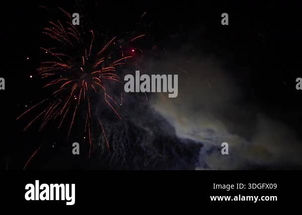 4K video of a vibrant fireworks display lighting up the night sky. The ...