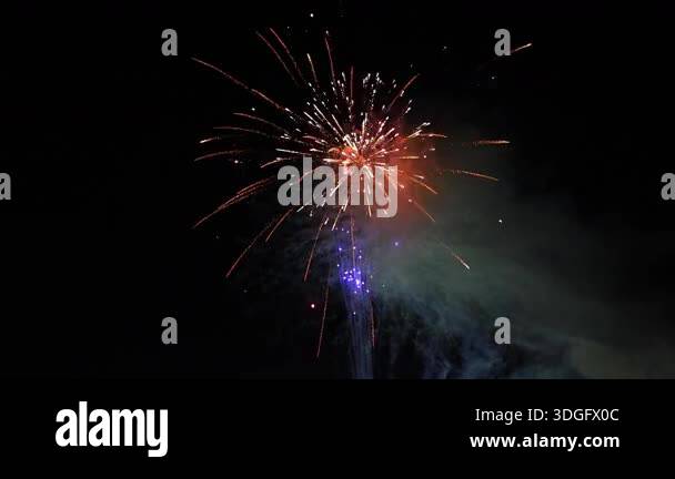 4K video of a vibrant fireworks display lighting up the night sky. The ...