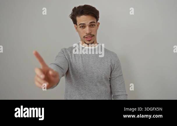 Young man gestures no with fingers over isolated white background ...