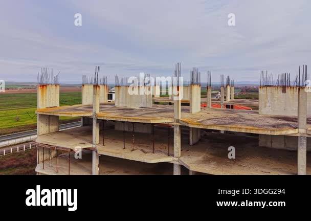 Aerial view shows a partially constructed building with exposed columns ...