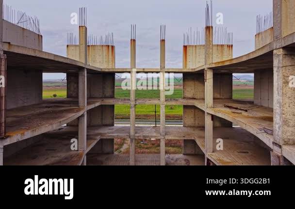 An aerial view reveals an unfinished construction site with exposed ...