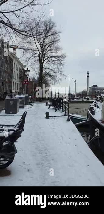 AMSTERDAM, NETHERLANDS - JANUARY 9, 2026: Winter walk along snowy ...