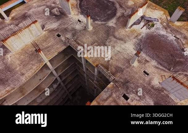 An aerial view captures a construction site showing deep excavation ...