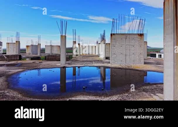 Aerial view of a construction site featuring concrete pillars with ...