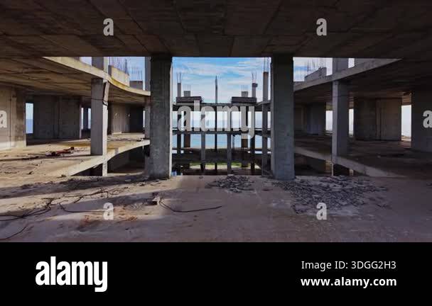 An aerial view reveals an unfinished structure overlooking water ...