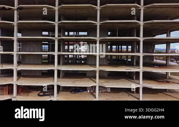 Aerial view shows a multi-story building under construction. The ...