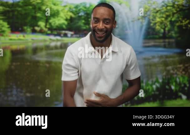 Young african american man points finger and holds stomach in a forest ...