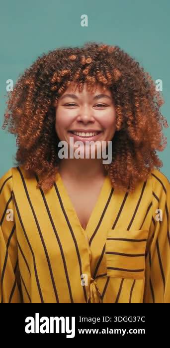 Hispanic woman wearing casual attire laughs standing on blue background ...