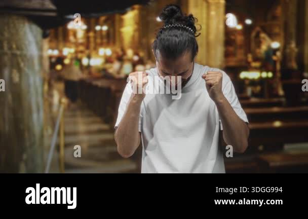 Man clenches fists and shouts inside an ornate church building among ...