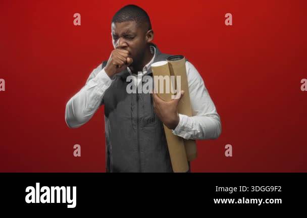 Man coughing into fist holding rolled architectural blueprints while ...