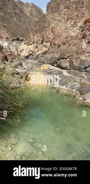 Natural mountain pools during a hiking route in Fujairah, UAE. Clear ...