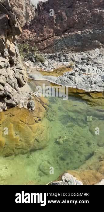 Natural mountain pools along a hiking trail in Fujairah, UAE, clear ...