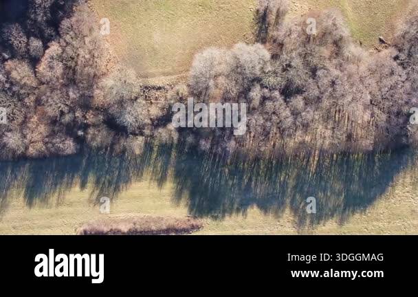 Sideways drone aerial drone shot of a rural landscape showing forest ...