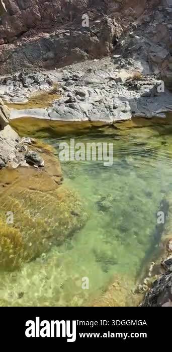 Natural mountain pools during a hiking route in Fujairah, UAE, crystal ...