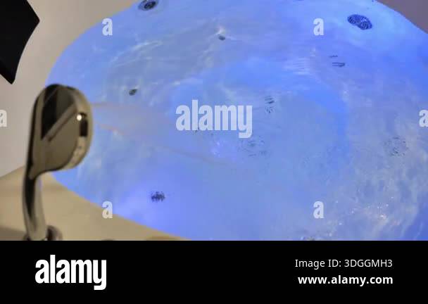 Bathing in a jacuzzi. Water bubbling in a jacuzzi with changing ...