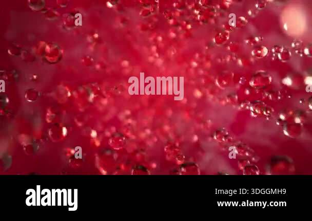 Super Slow Motion Shot of Flying Red Lemonade Liquid Drops Towards ...