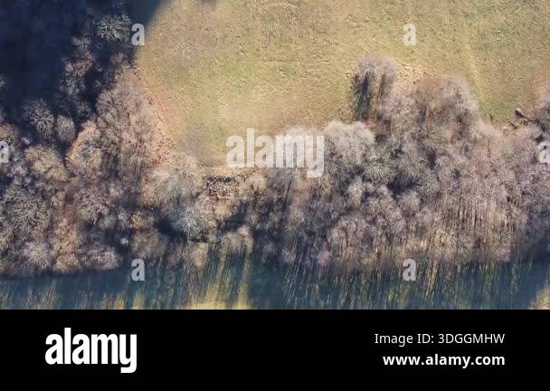 Sideways drone aerial drone shot of a rural landscape showing forest ...