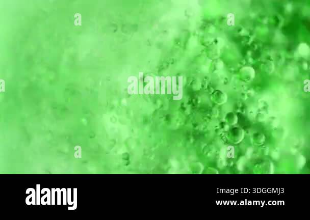 Super Slow Motion Shot of Flowing Bubbles in Green Glass Bottle at ...