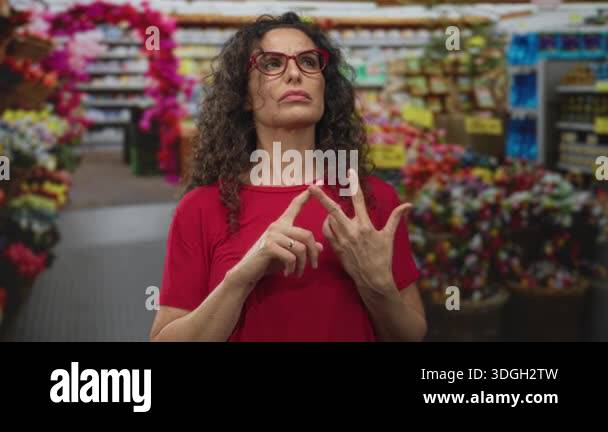 Woman counting fingers by her face surrounded by vibrant flower baskets ...