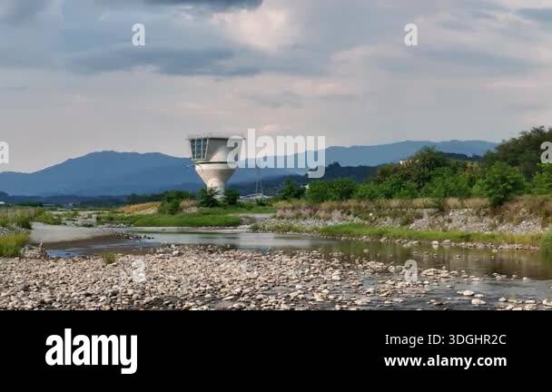 Water tower near river with mountains in background Stock Video Footage ...