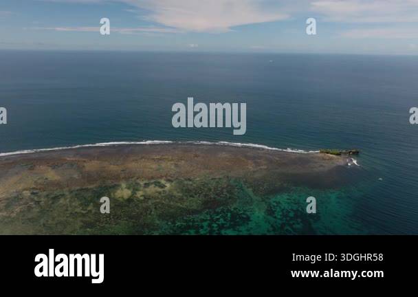 Shallow coastal waters with coral reef near open ocean. Siargao ...