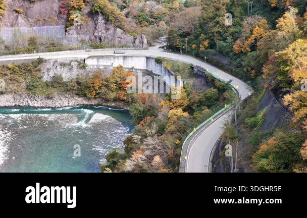 Winding road along river surrounded by autumn trees Stock Video Footage ...