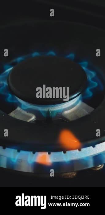 Kitchen burner is ignited in a bright blue flame, fire for cooking ...