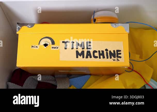 A man hand pulls the handle of a white box, which is slightly open ...