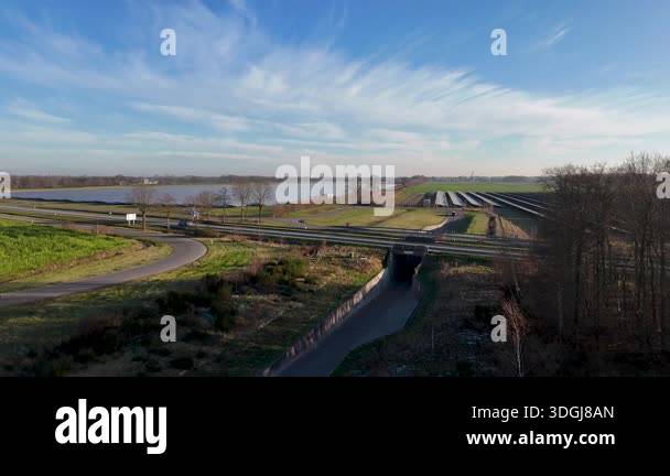 Wide Levee Panorama Under Blue Sky, Drone Captures Meandering Channel ...