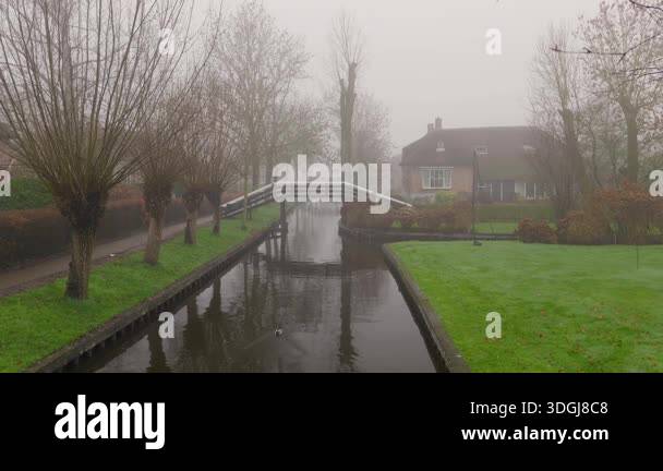 Misty Canal With Arched Bridge, Quiet Morning, Reflective Water ...