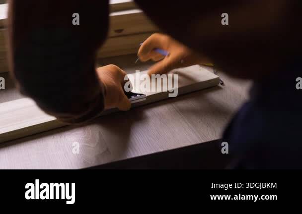 Carpenter elderly man working in carpentry workshop, measuring wooden ...
