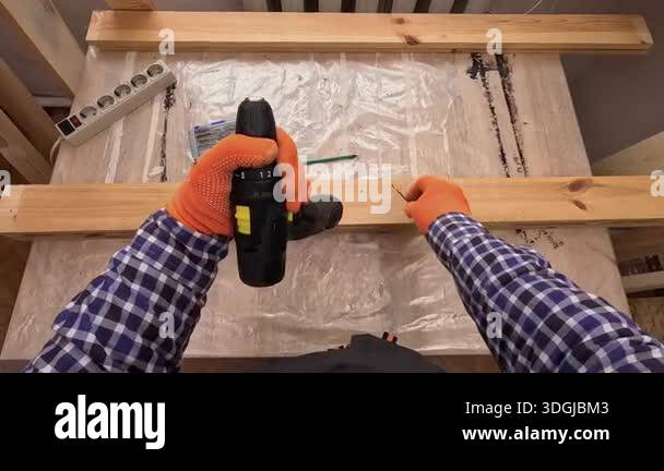 POV close up of hands unscrewing the chuck of a cordless drill to ...