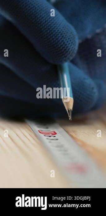 Measuring 40 centimeters of a wooden board using a tape measure in a ...