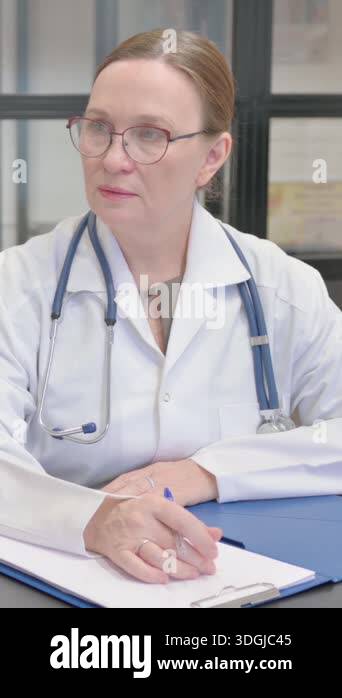Old Lady Doctor Talking about Treatment Plan with Patient, vertical ...