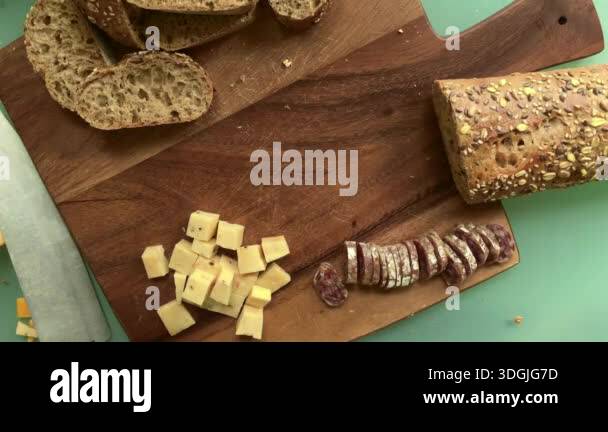 Sliced bread cheese and salami on board Stock Video Footage - Alamy