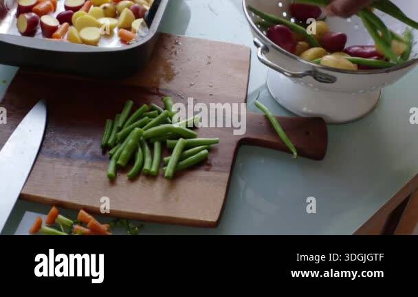 Person preparing fresh vegetables on wooden cutting board Stock Video ...