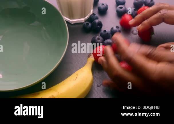 Person hands preparing fruits for morning breakfast cereal Stock Video ...