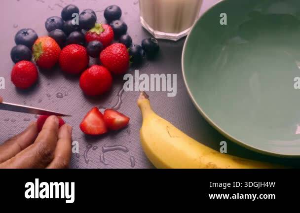 Person hands preparing fruits for morning breakfast cereal Stock Video ...