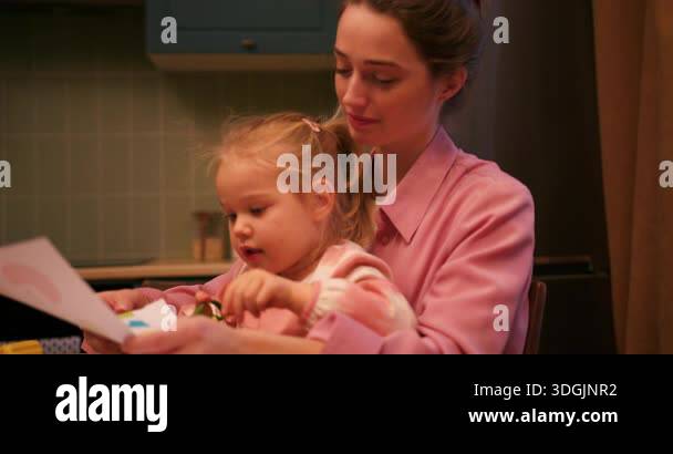 Young caring mother spending quality time with her cute little daughter ...