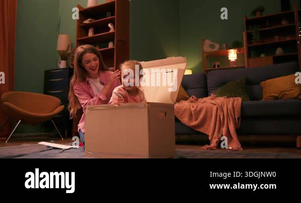 Happy mother finding her little daughter hiding inside a large ...