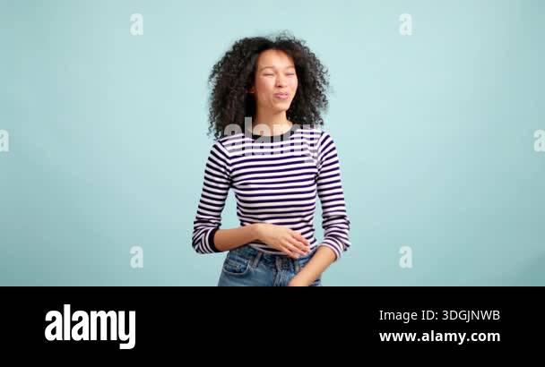 Young biracial woman with curly hair smiling and laughing joyfully ...