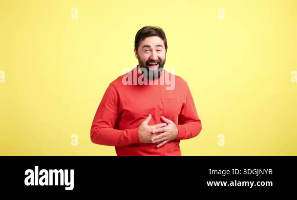 Middle aged man with a beard wearing a red shirt laughing out loud ...