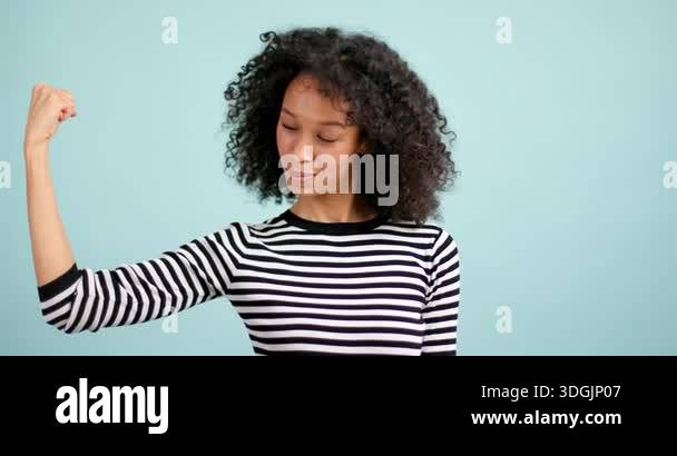 Powerful and independent mixed race woman showing her strength on a ...