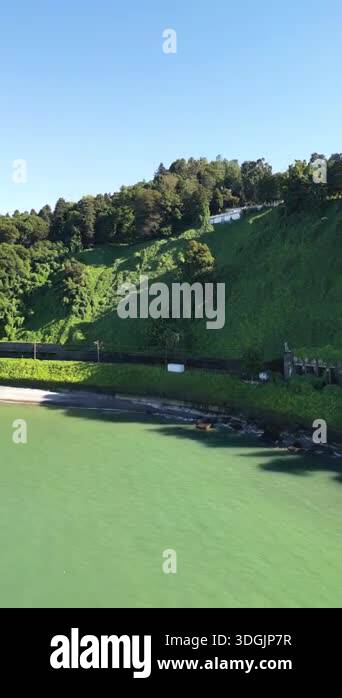 Vertical aerial view, evergreen botanical garden and railway in Batumi ...