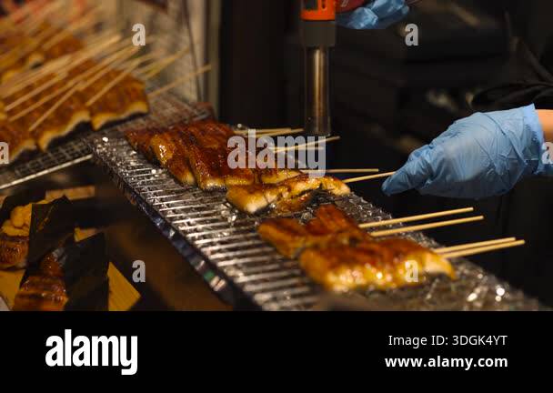 Cooking skewered meat on a charcoal grill Stock Video Footage - Alamy
