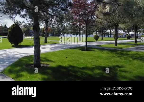 Smooth Camera Movement Through Modern Green Park with Trees, Lawn and ...