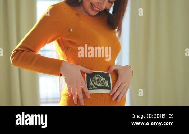 Prenatal ultrasound screening. Pregnant woman holding sonogram picture ...