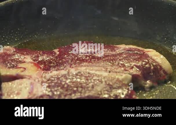 Close-up slow motion footage of grilling raw steak, barbecue party in ...
