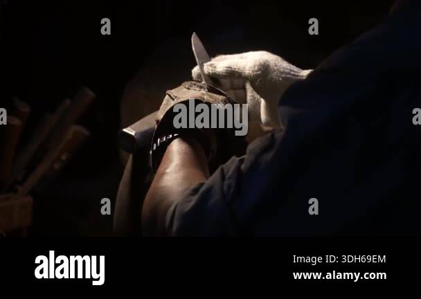 A craftsman carefully straightening a knife Stock Video Footage - Alamy