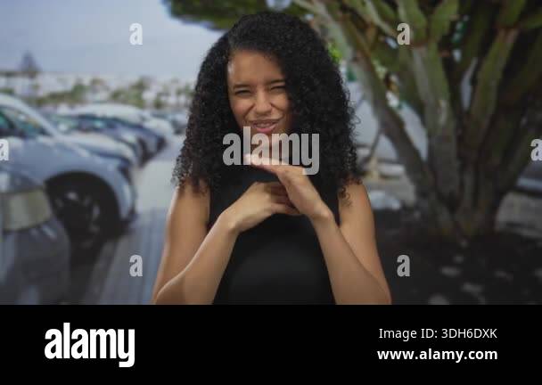 Young hispanic latina woman points index finger while pressing hand on ...
